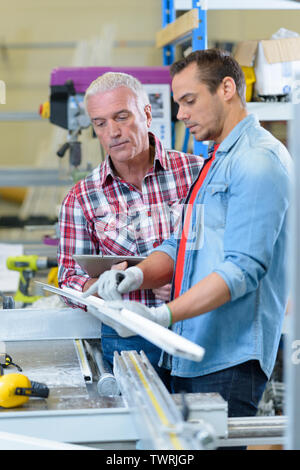 boss and worker together in a carpenter's workshop Stock Photo - Alamy
