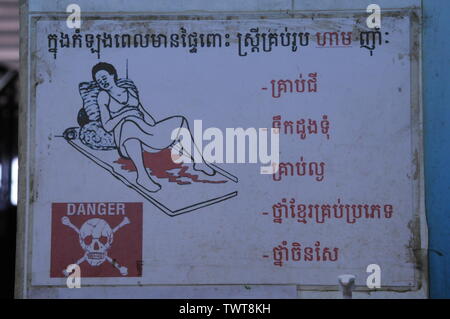 The dangers of childbirth. bilingual warning sign about giving birth at ...