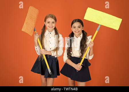 Super duper cleaning. Cute schoolgirls holding floor mops. School ...