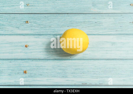 Lemon with teal wood pattern background Stock Photo - Alamy