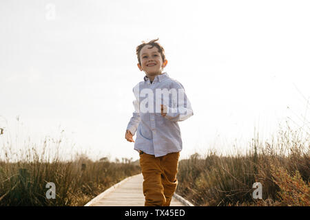 Happy little boy running. Front and rear view Stock Photo - Alamy