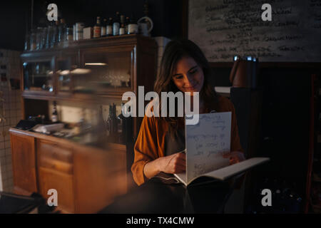 Young caucasian shopkeeper woman smiling happy working at clothing ...