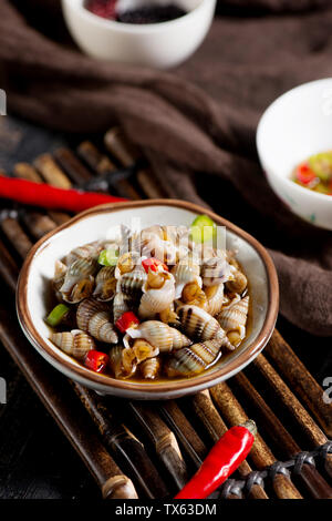 Spicy seafood sea melon seeds snail crab pliers Stock Photo - Alamy