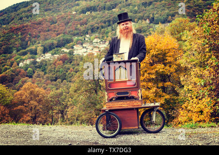 Man with organ outdoors Stock Photo - Alamy