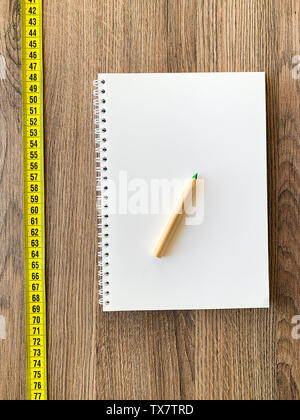 Shaping and fitness. Dumbbells, cyan jump rope and measure tape Stock ...