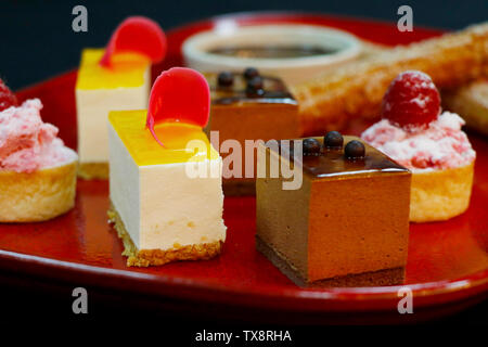 assorted french pastries in a red color plate Stock Photo - Alamy