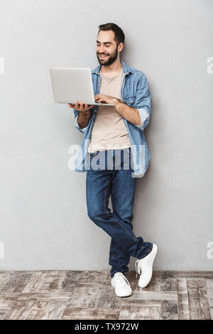 Full length photo of optimistic man in striped t-shirt smiling and ...