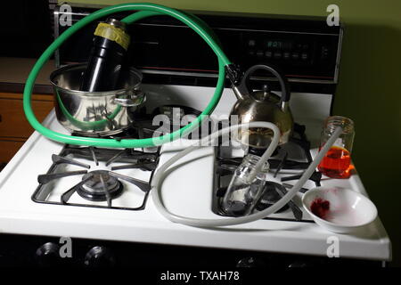 Crudely constructed meth lab on a stove top consisting of crushed nasal ...