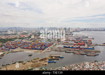 Trading port in Manila. Cargo cranes and containers in the port ...