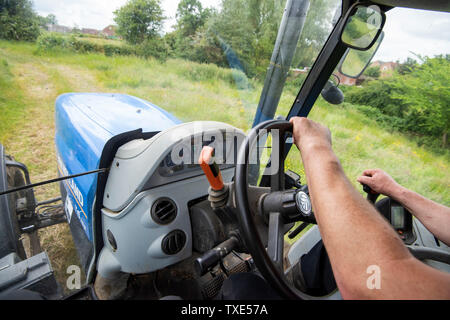 Tractor being driven though Rural Leicestershire, England UK Stock ...
