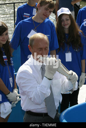 Russian President Vladimir Putin kisses a Alabai puppy gifted him by ...