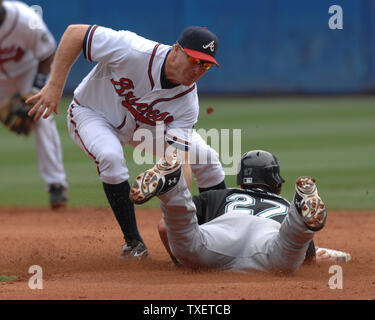 Atlanta Braves second baseman Pete Orr reaches to tag Florida Marlins ...