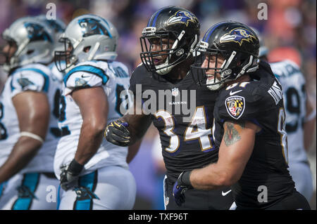 Baltimore Ravens running back Owen Wright, top, is stopped by Tampa Bay ...