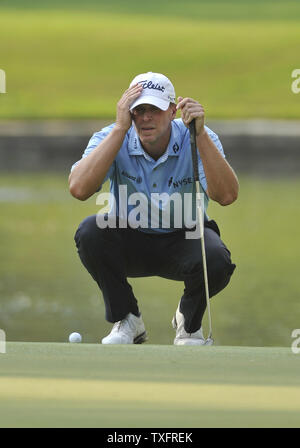 Steve Stricker lines up a putt on the 18th green during the first round ...