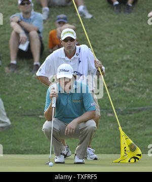 Jason Dufner and caddie Kevin Baile walk off of the 14th green in the ...
