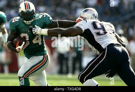 New England Patriots linebacker Adalius Thomas (96) runs through a ball ...