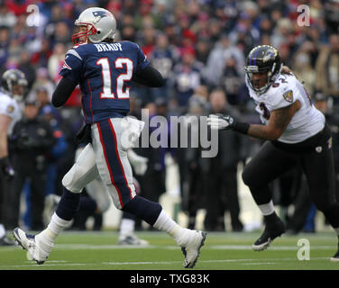 Baltimore Ravens nose tackle Terrence Cody (62), left, is helped off ...