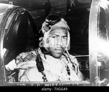 Ensign Jesse L. Brown, seated in the cockpit of an F4U-4 Corsair ...