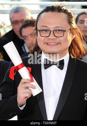 Qiu Yang arrives at the award photocall after receiving the "Best Short ...