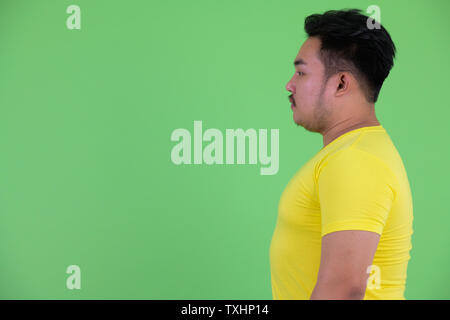 Side profile of a young chubby man transformation into a slim happy ...