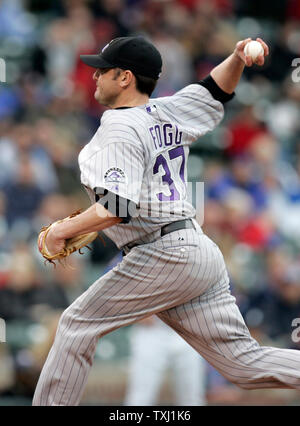 Colorado Rockies starting pitcher Josh Fogg, back, waits to confer with ...
