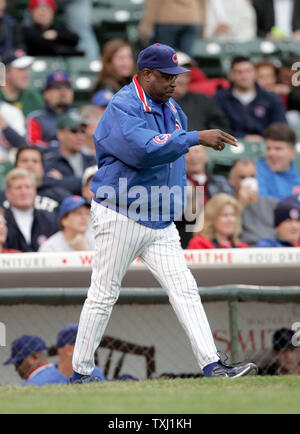 Chicago Cubs manager Dusty Baker (12) and trainer Ed Halbur, right ...