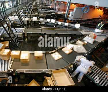 Workers sort packages at UPS' Chicago Area Consolidation Hub in ...