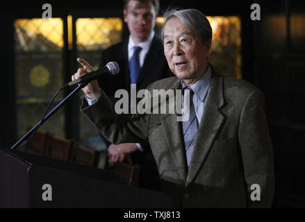University of Chicago professor Yoichiro Nambu (R) is congratulated by ...