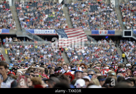 Fans watch as the United States flag is unfurled in this general view ...