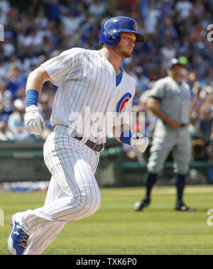 Chicago Cubs' Ian Happ runs the bases after he hits a home run against ...