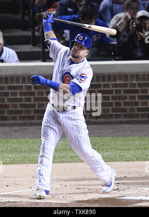 Chicago Cubs' Kyle Schwarber watches his home run off Los Angeles ...