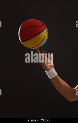 Hand balancing basketball on fingertip, showcasing skill, coordination ...
