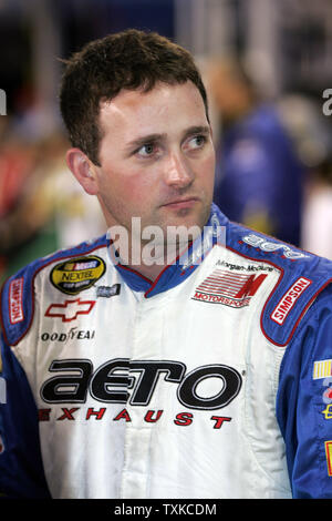 Race car driver Scott Wimmer sits in his car as he awaits his turn on ...