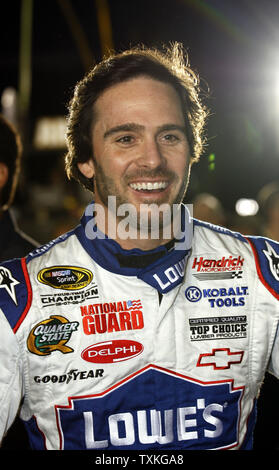 Race car driver Jimmie Johnson walks on pit road before the NASCAR Coca ...