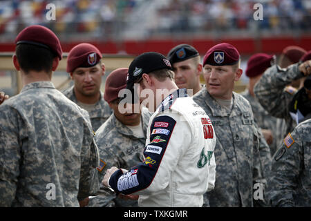 Dale Earnhardt Jr signs autographs before practice for Sunday's NASCAR ...