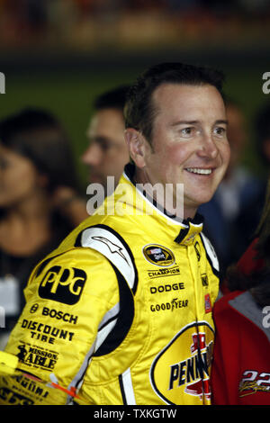 Kurt Busch stands by his car in the staging area before his second drag ...
