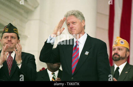 Former U.S. President Bill Clinton salutes to applauding supports as he ...