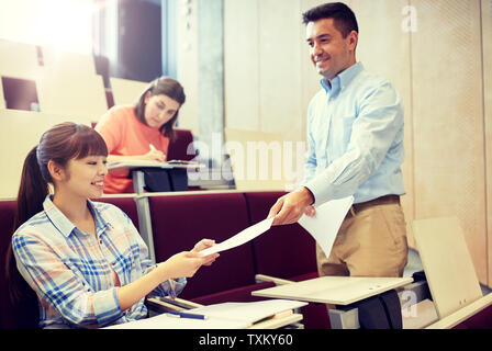 teacher giving tests to students at lecture Stock Photo - Alamy