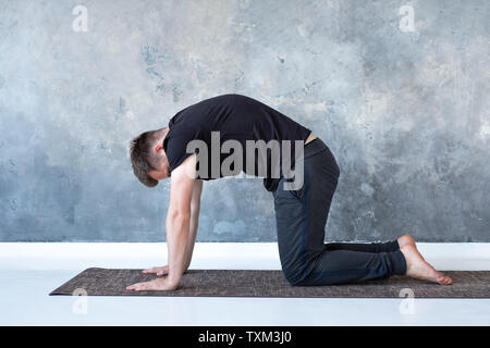 Flexible yoga man practices yoga asana balasana child's pose Stock ...
