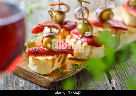 Spanish pinchos: Skewer snacks made of grilled bread with roasted and ...