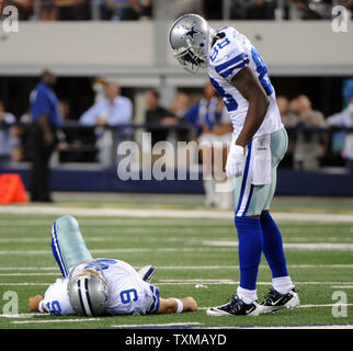 Injured Dallas Cowboys quarterback Tony Romo, center, walks with team ...