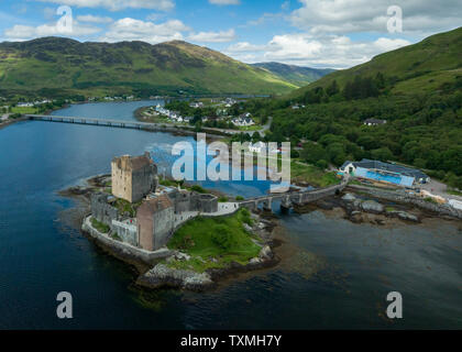 An aerial view of Eilean Donan Castle in the Scottish Highlands on a ...
