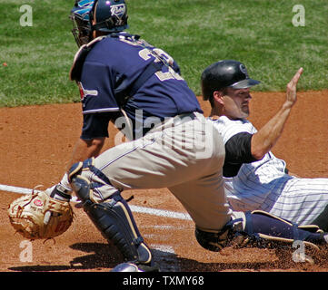 San Diego Padres catcher Josh Bard is sent flying by Corey Koskie of ...