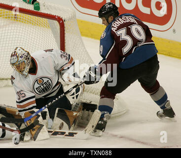 Edmonton Oilers goalie Dwayne Roloson (35) blocks a shot in front of St ...