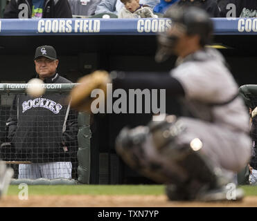 Colorado Rockies manager Clint Hurdle, left, carries his year-old ...