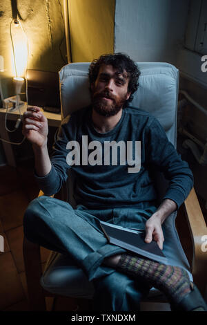 Portrait of a smoking young bearded man adventurer relaxing in the ...