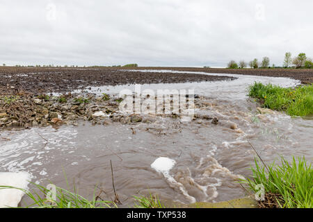 Farm field waterway flowing water after heavy rain and storms caused ...