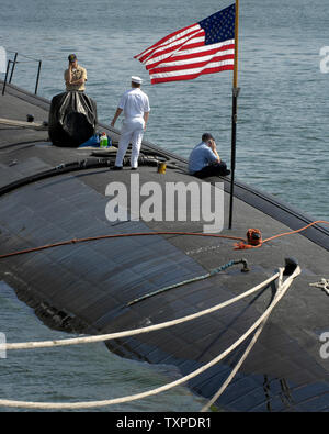Crew members aboard Los Angeles-class attack submarine USS Augusta tend ...