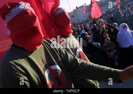 Palestinian militants of Popular Resistance Committees burn an Israeli ...