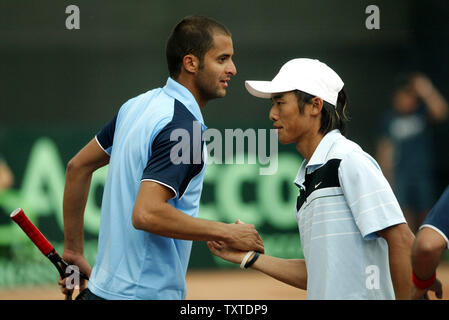 Iran's Ashkan Shokoofi (L) shakes hand with Hong Kong's Hoh-Kong So ...